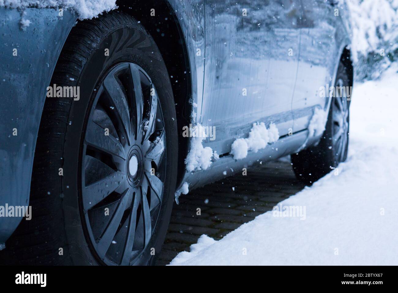 Snow-covered car in side view with tire tread and rim in Lower Bavaria ...