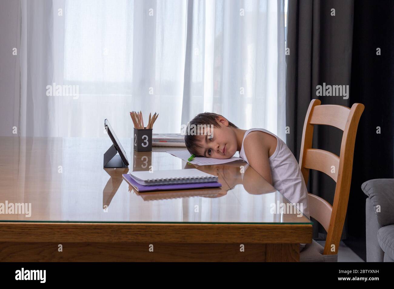 boy put his head on desk, he doesn want to do homework, children ...