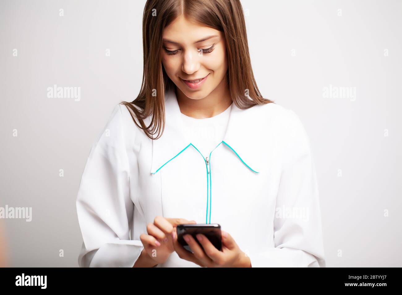 Doctor at the clinic checks the text messages on the phone Stock Photo ...