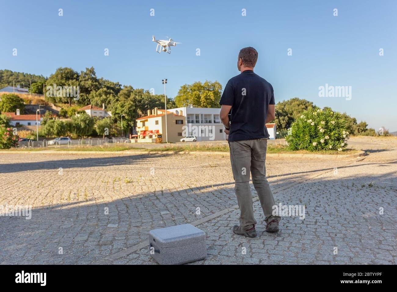 Man, an engineer pilot, a drone, prepares air device for take-off, for ...