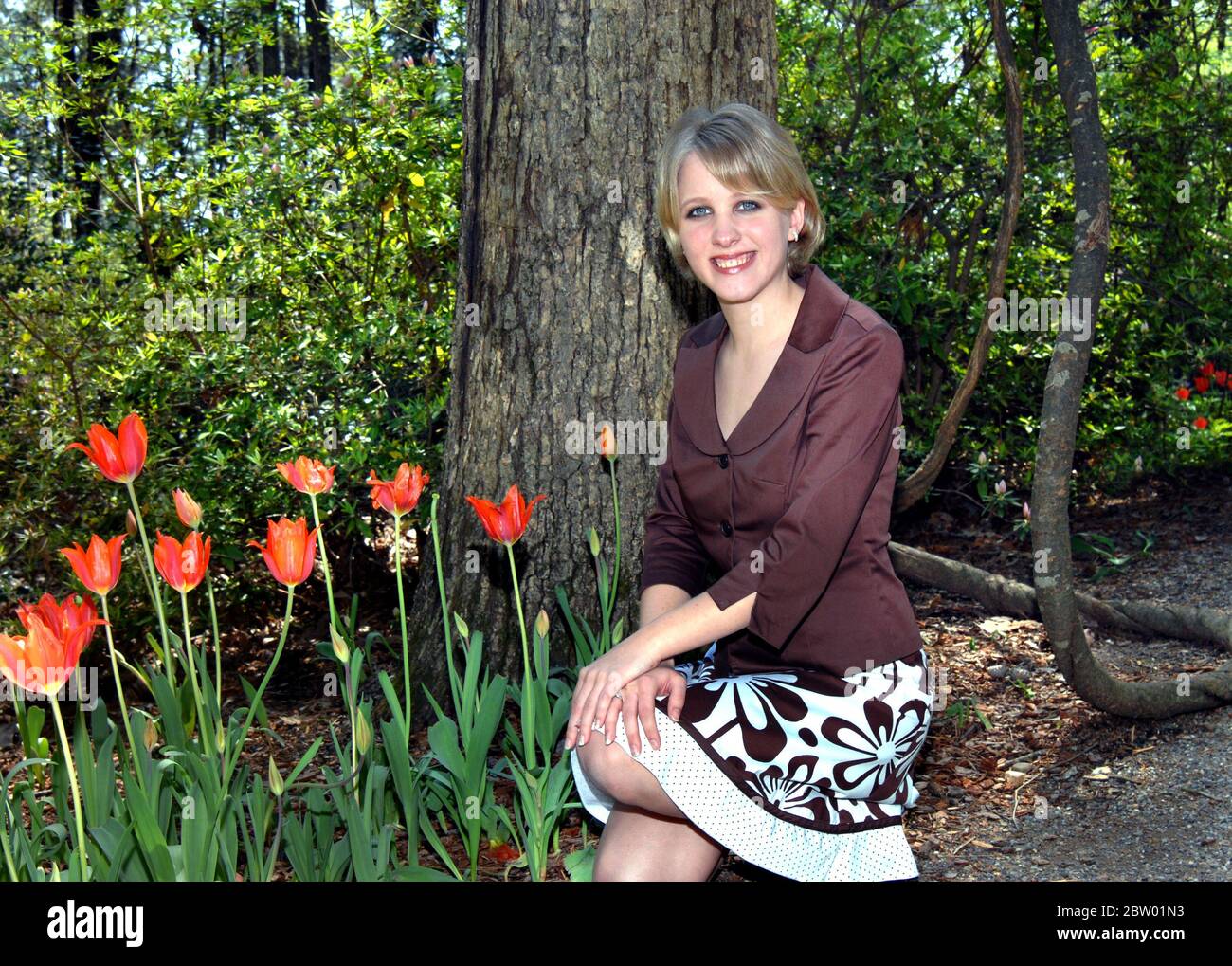 Beautiful young woman enjoys the Springtime tulips at Garvans Woodland ...