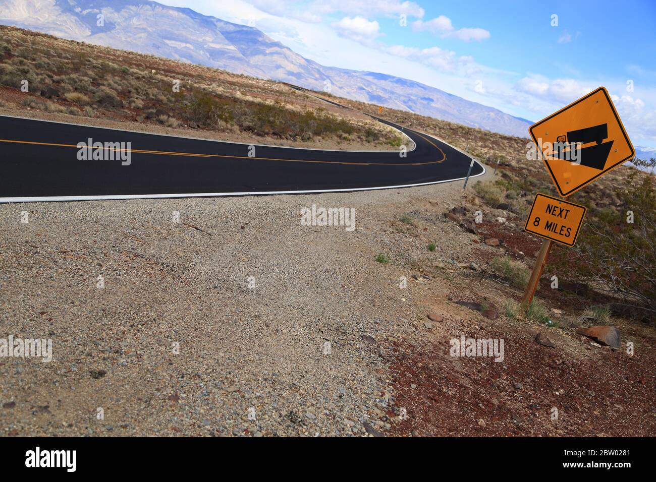 A lonely desert road with a steep hill, near Death Valley Stock Photo ...