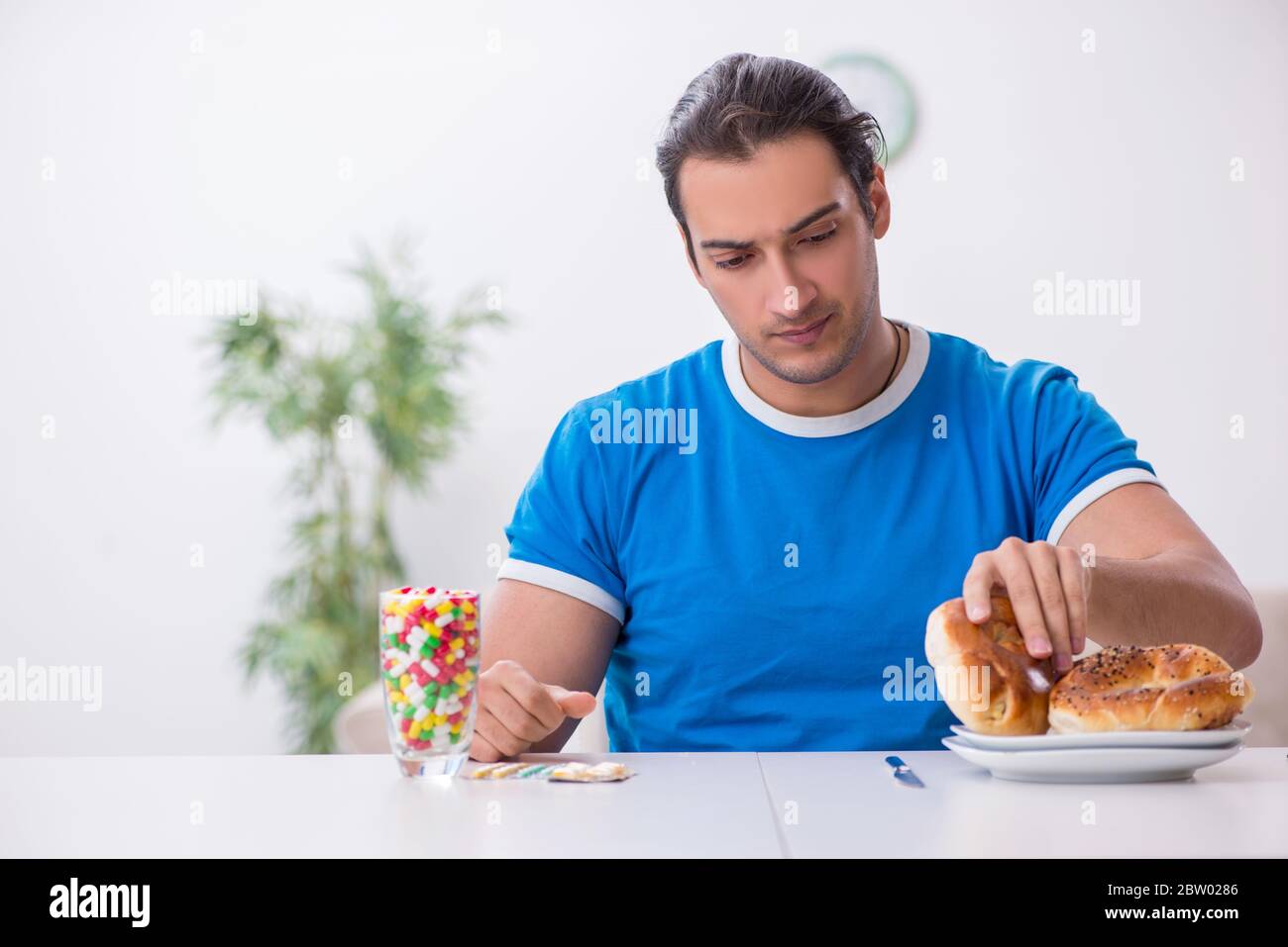 Hungry young man waiting dinner hi-res stock photography and images - Alamy
