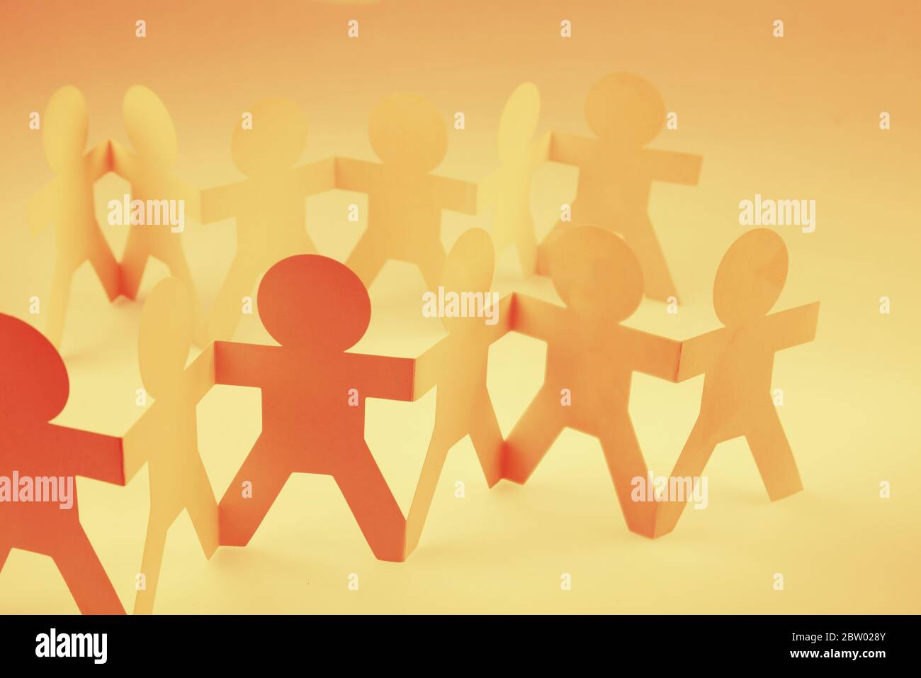 Paper chain team holding hands. Teamwork. Partnership Stock Photo - Alamy