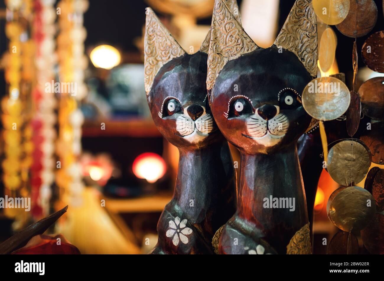 handcrafted oriental wooden carved cats in a bazaar market stall Stock ...