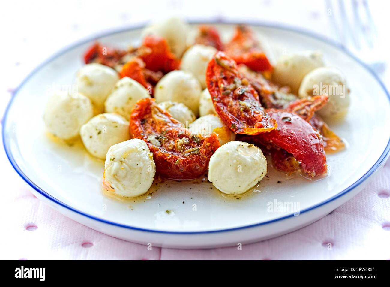 Mozzarella cheese balls with sun dried tomatoes Stock Photo - Alamy