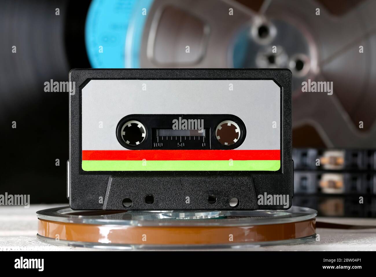 A three-color labeled the compact cassette is shown together with other ...