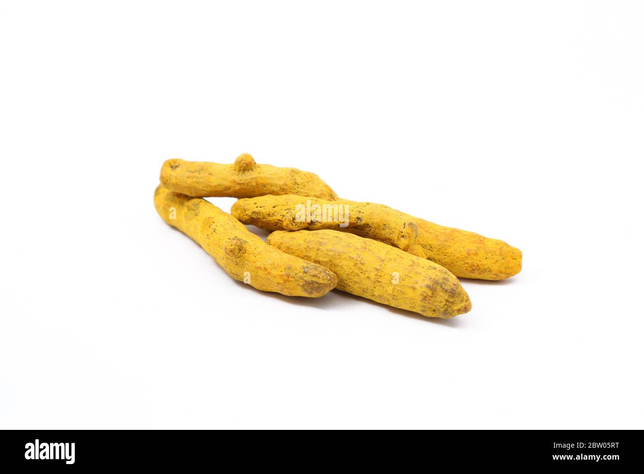 Turmeric roots on white background Stock Photo - Alamy