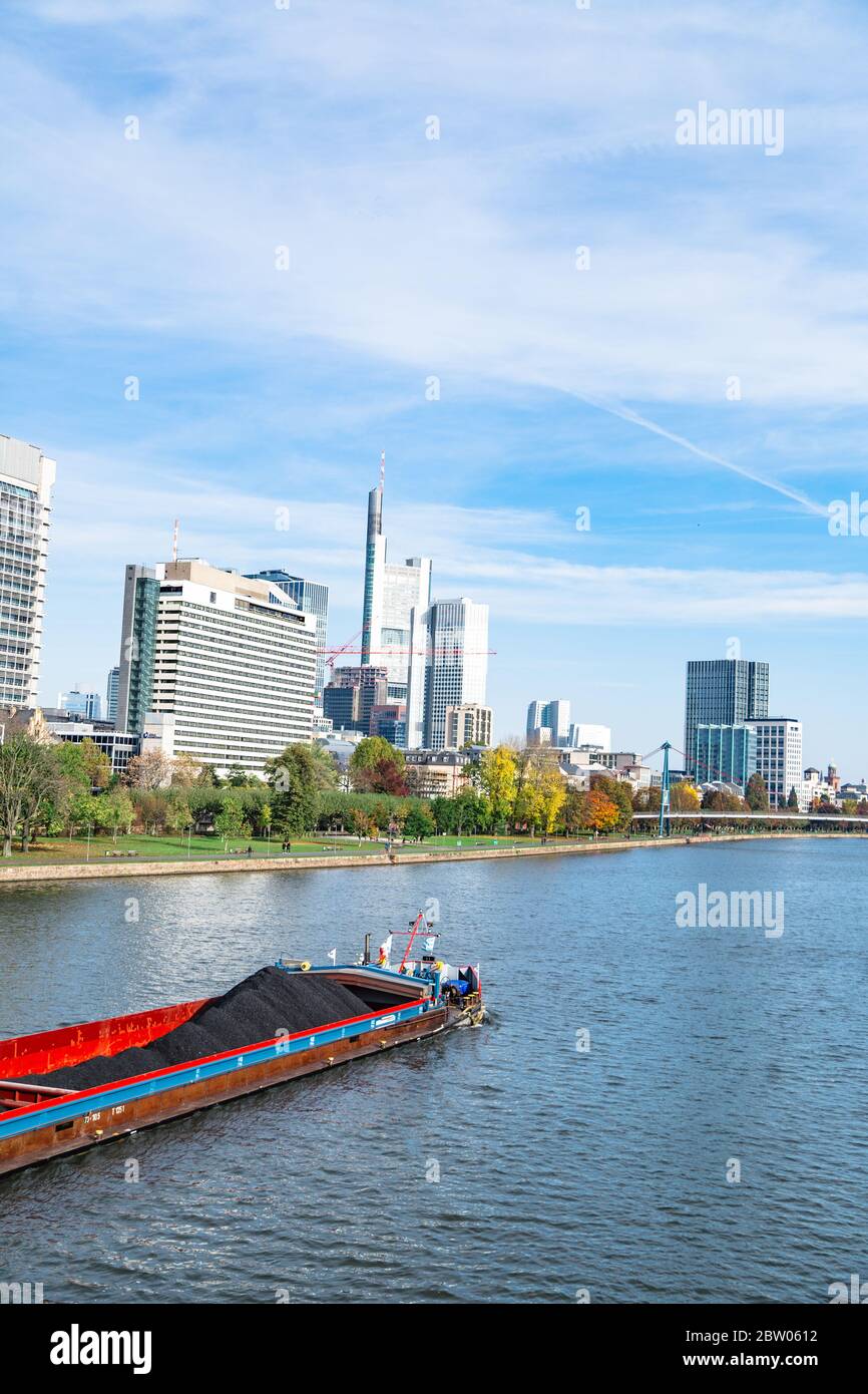 Barge floats on river on background of skyscrapers Stock Photo - Alamy