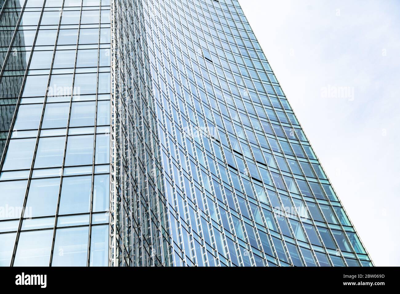 Bottom view of blue skyscraper with glass walls Stock Photo - Alamy