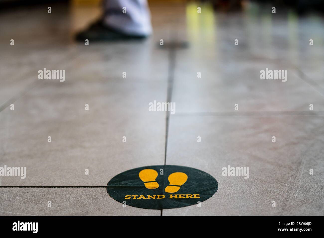 Stand here foot sign or symbol on the floor in coffee shop Stock Photo ...