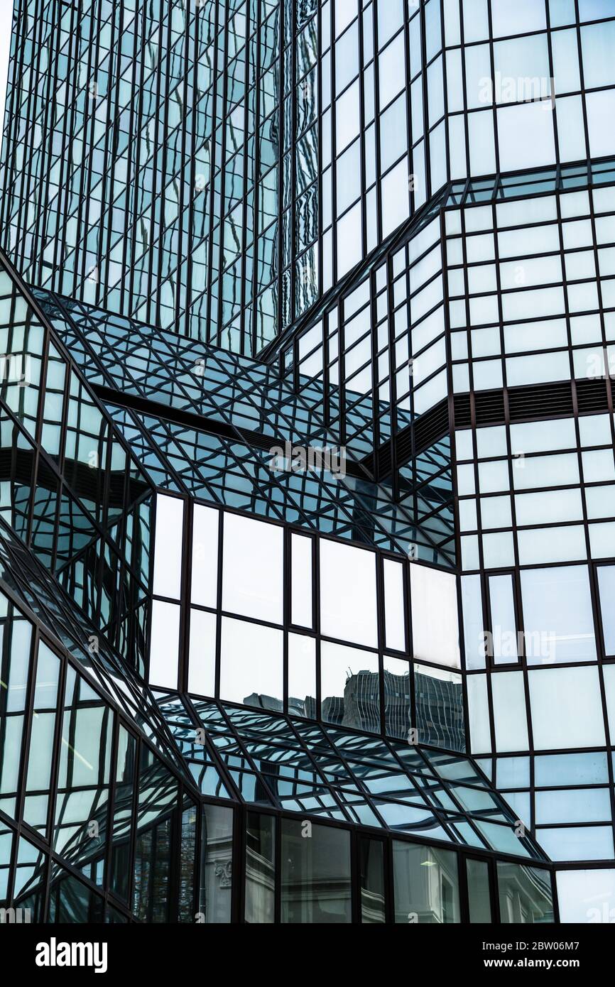 Glass walls of skyscraper reflect other houses Stock Photo - Alamy