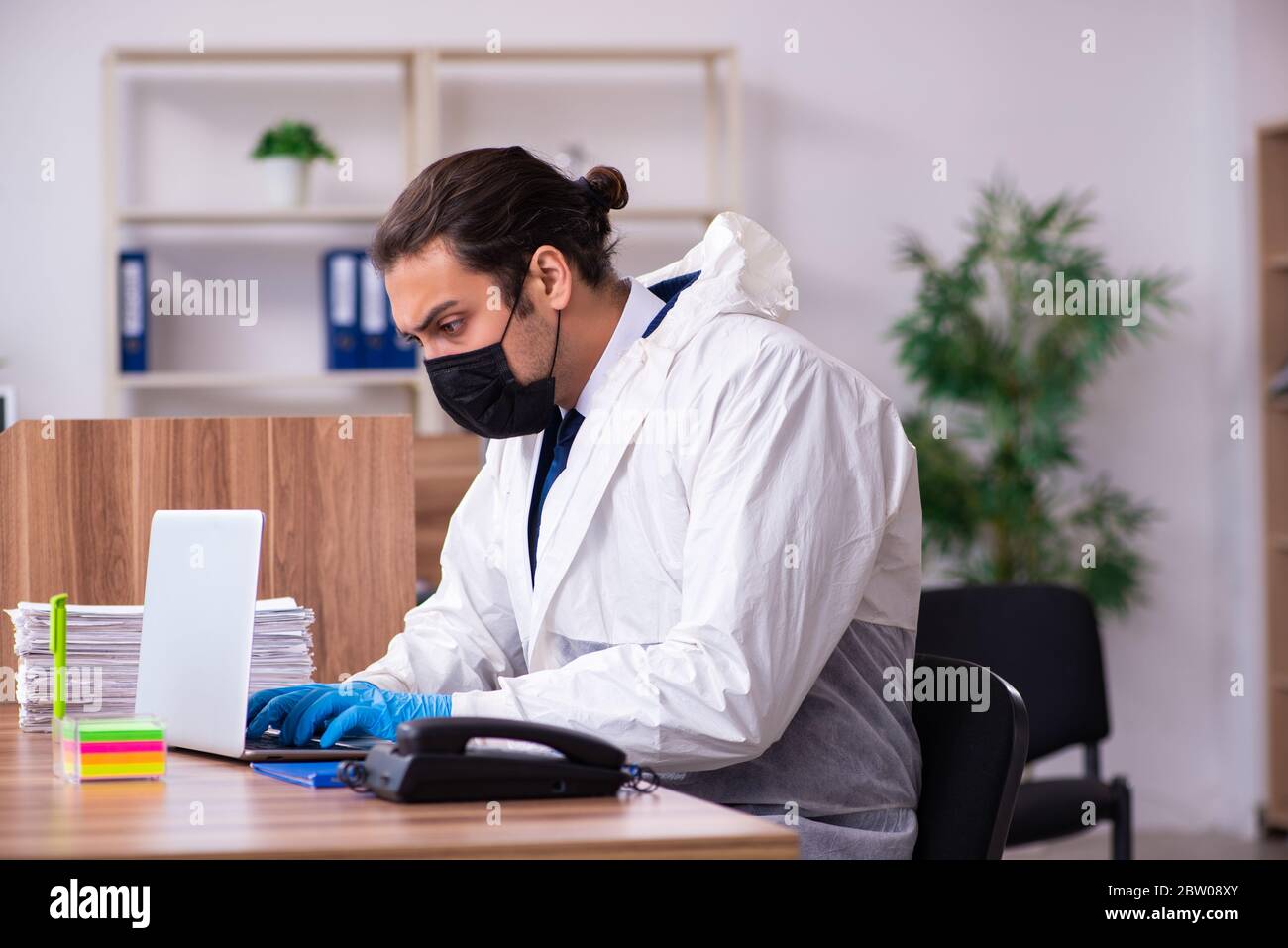 Young male employee in the self-isolation concept Stock Photo - Alamy