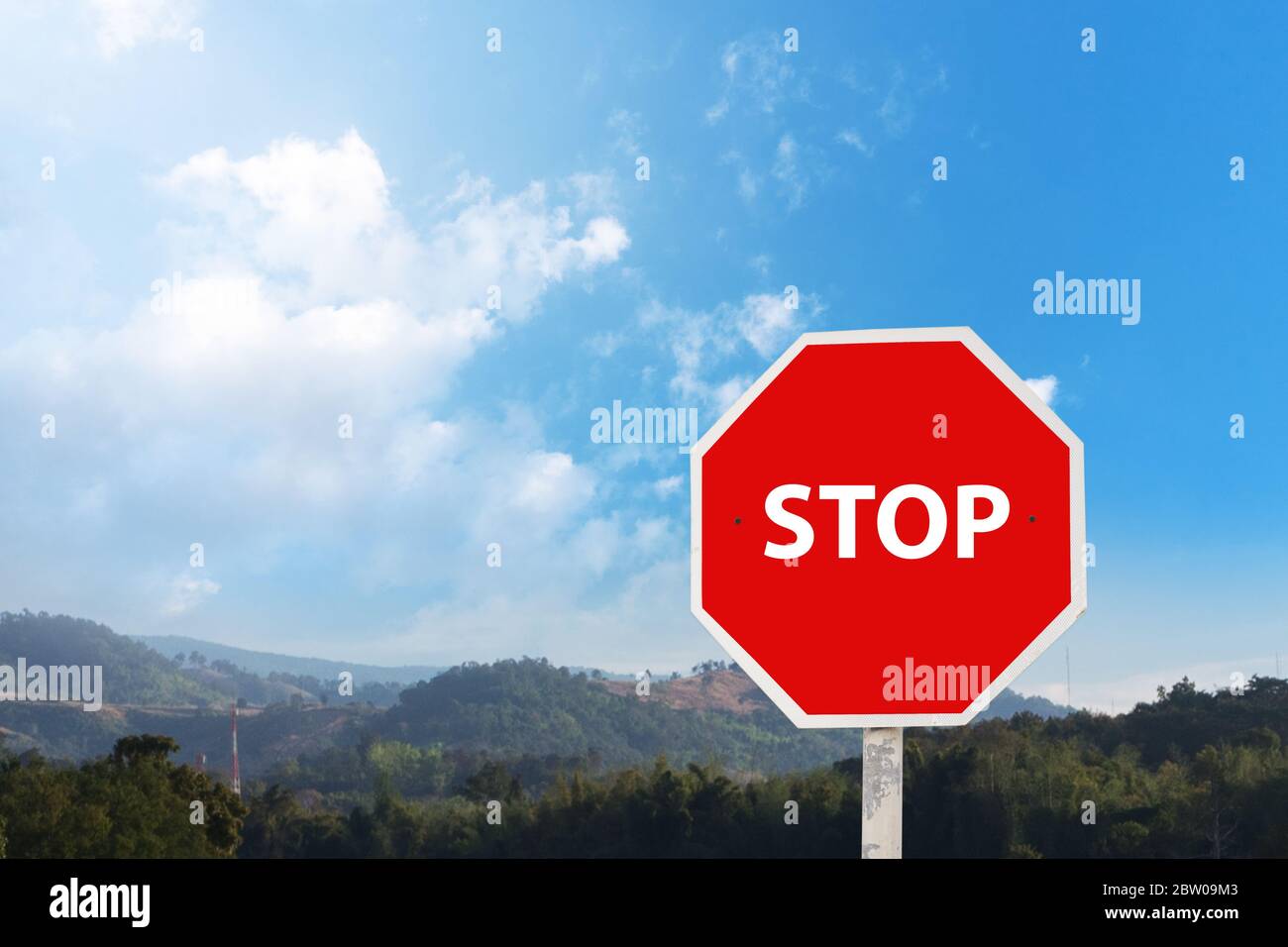 Stop sign on the blue sky.Stop warning traffic sign on a road Stock ...