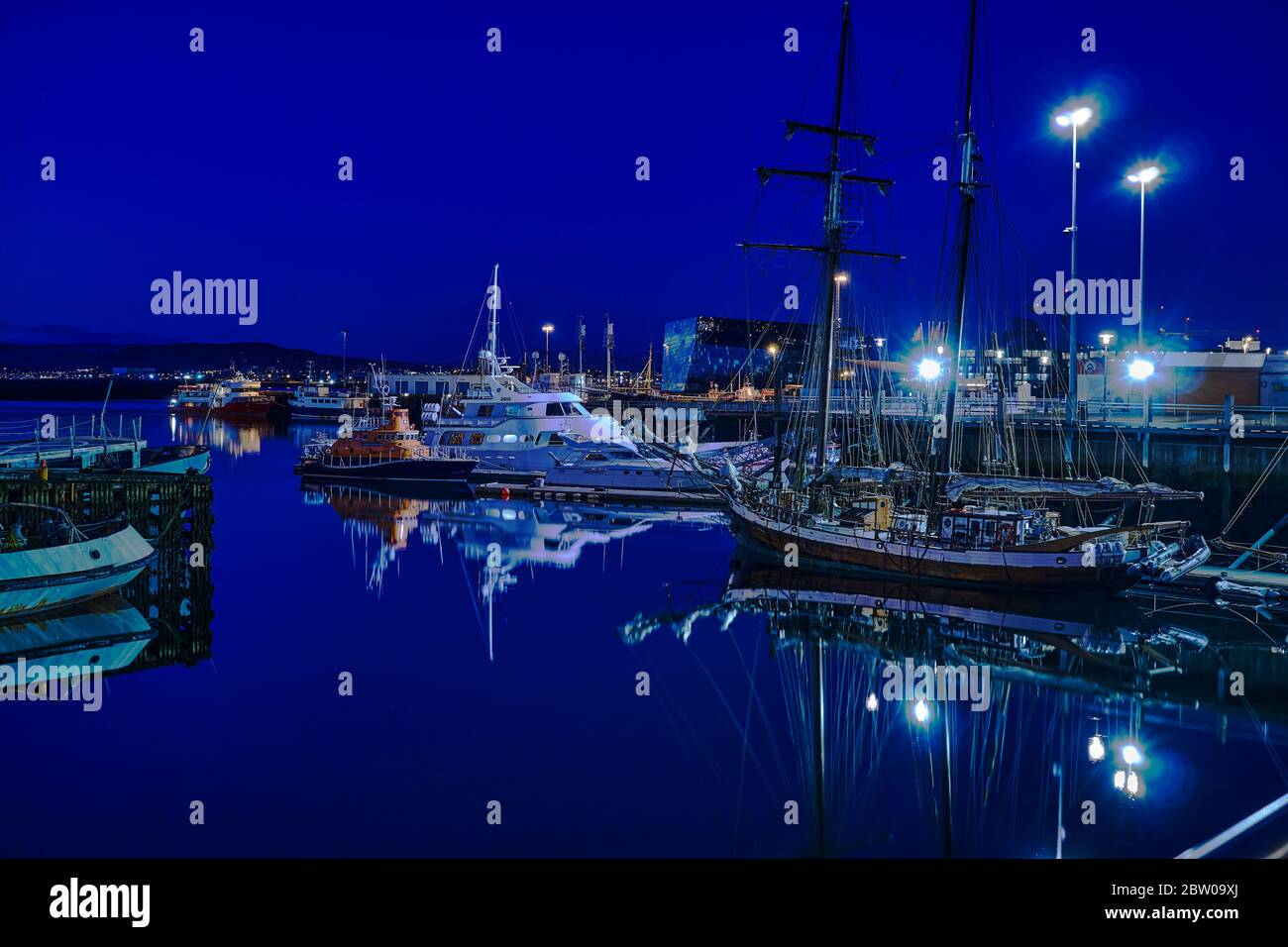 Early summer night view over Reykjavik harbour, boats, lights in the ...