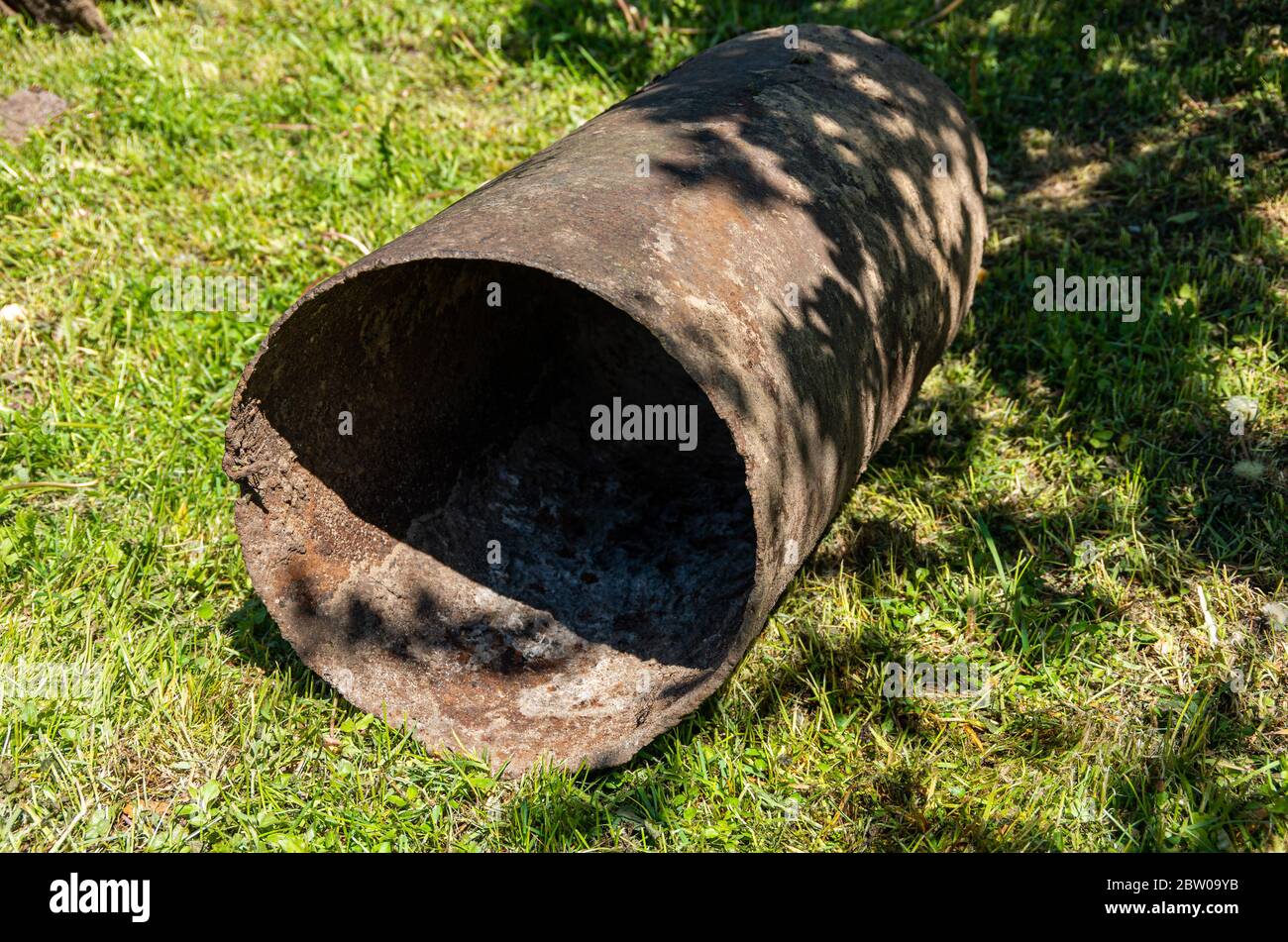 An old large pipe for a smokehouse, green grass Stock Photo - Alamy