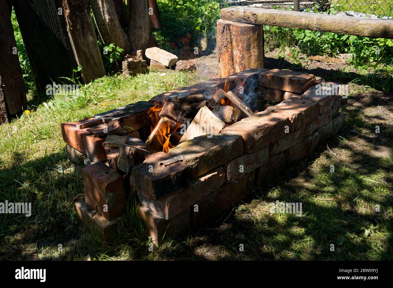 Homemade grill in a country house, burning firewood, there is a fire ...