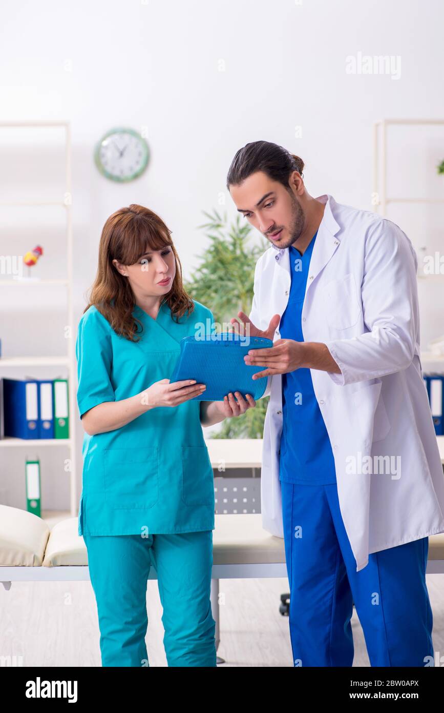 Two doctors colleagues working in hospital Stock Photo - Alamy
