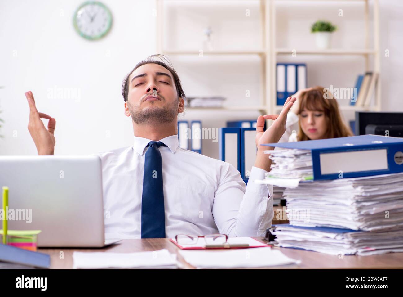 Two employees working in the office environment Stock Photo - Alamy