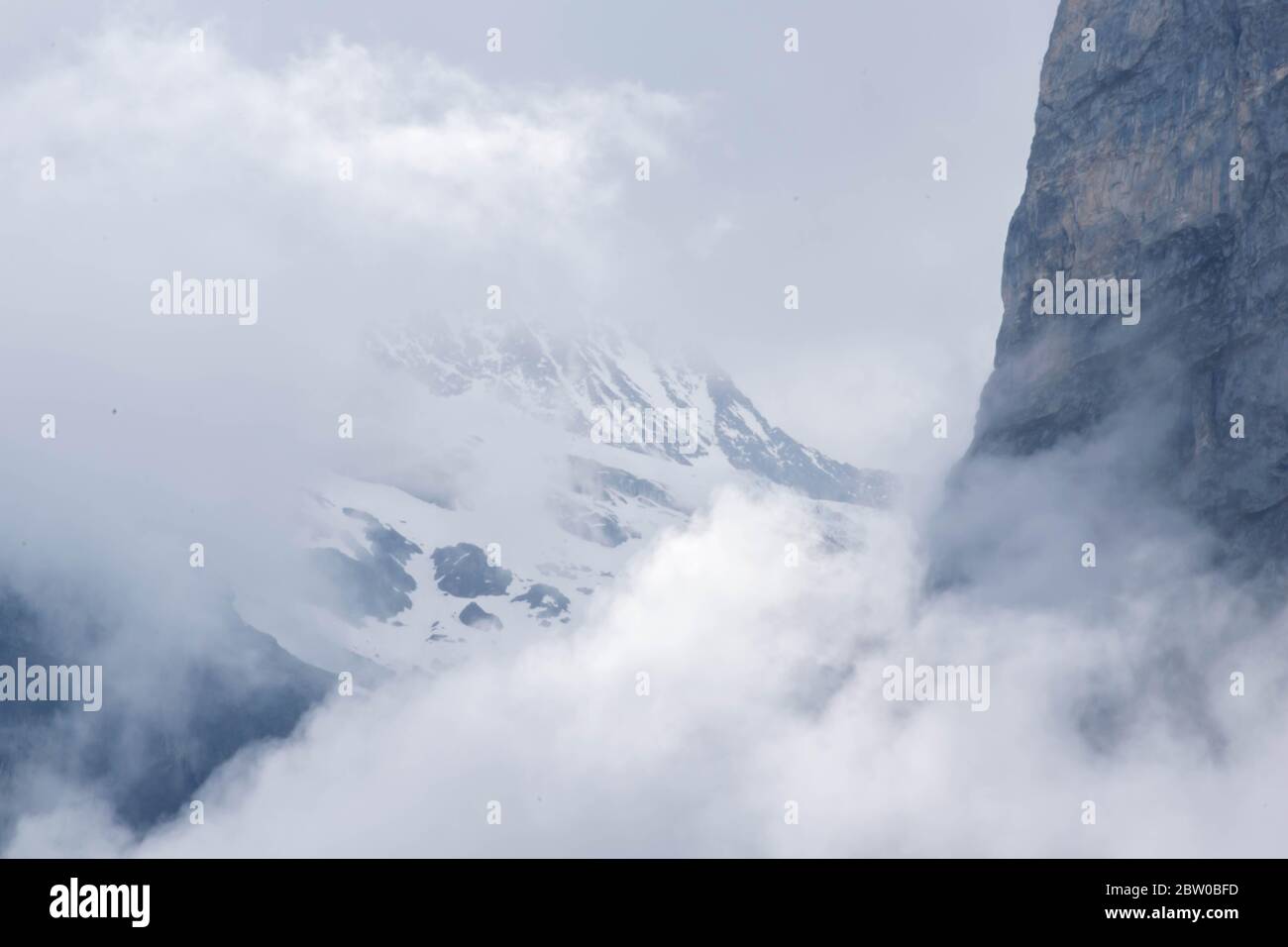 Cloudy and Snowy Peaks of Alps Mountains Stock Photo - Alamy