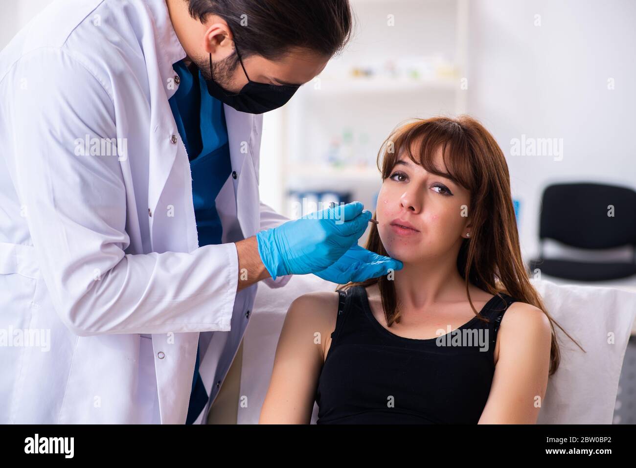 Young woman visiting doctor dermatologist Stock Photo - Alamy