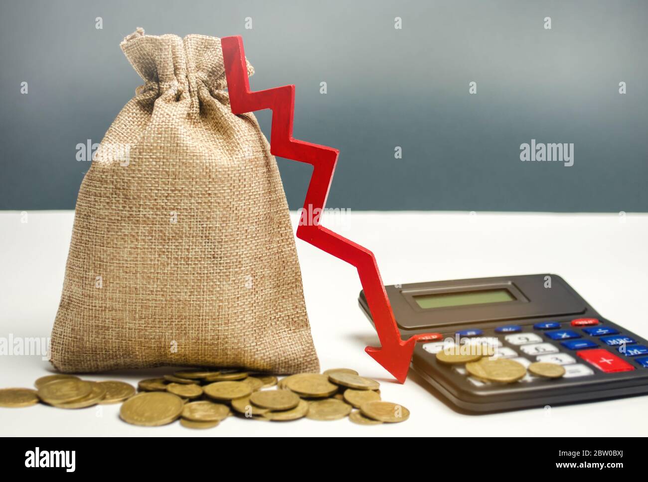 Money bag and red arrow down. Economic difficulties. Stagnation ...