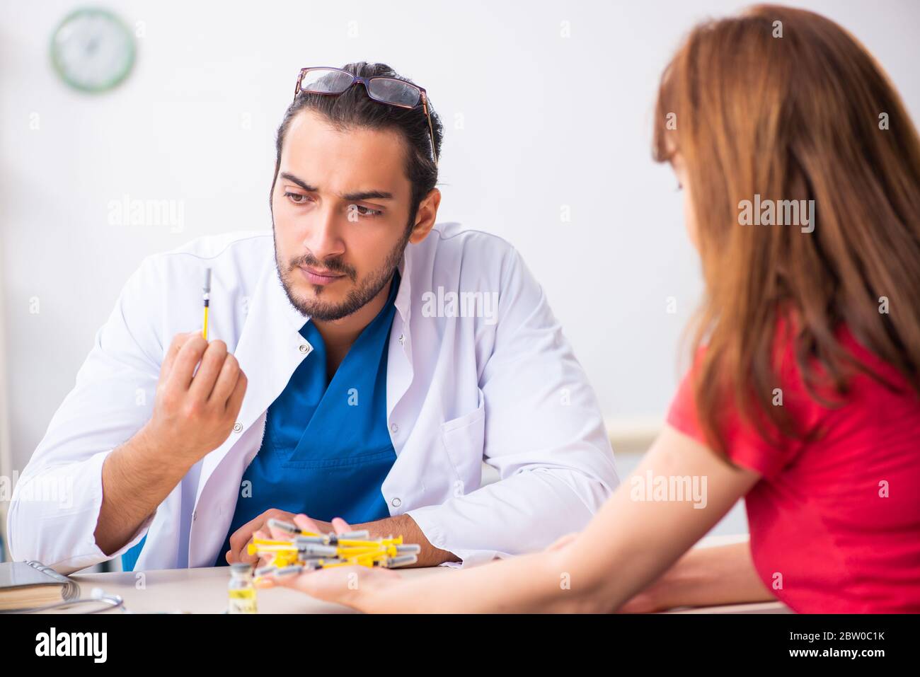 Female diabetic patient visiting young doctor Stock Photo - Alamy