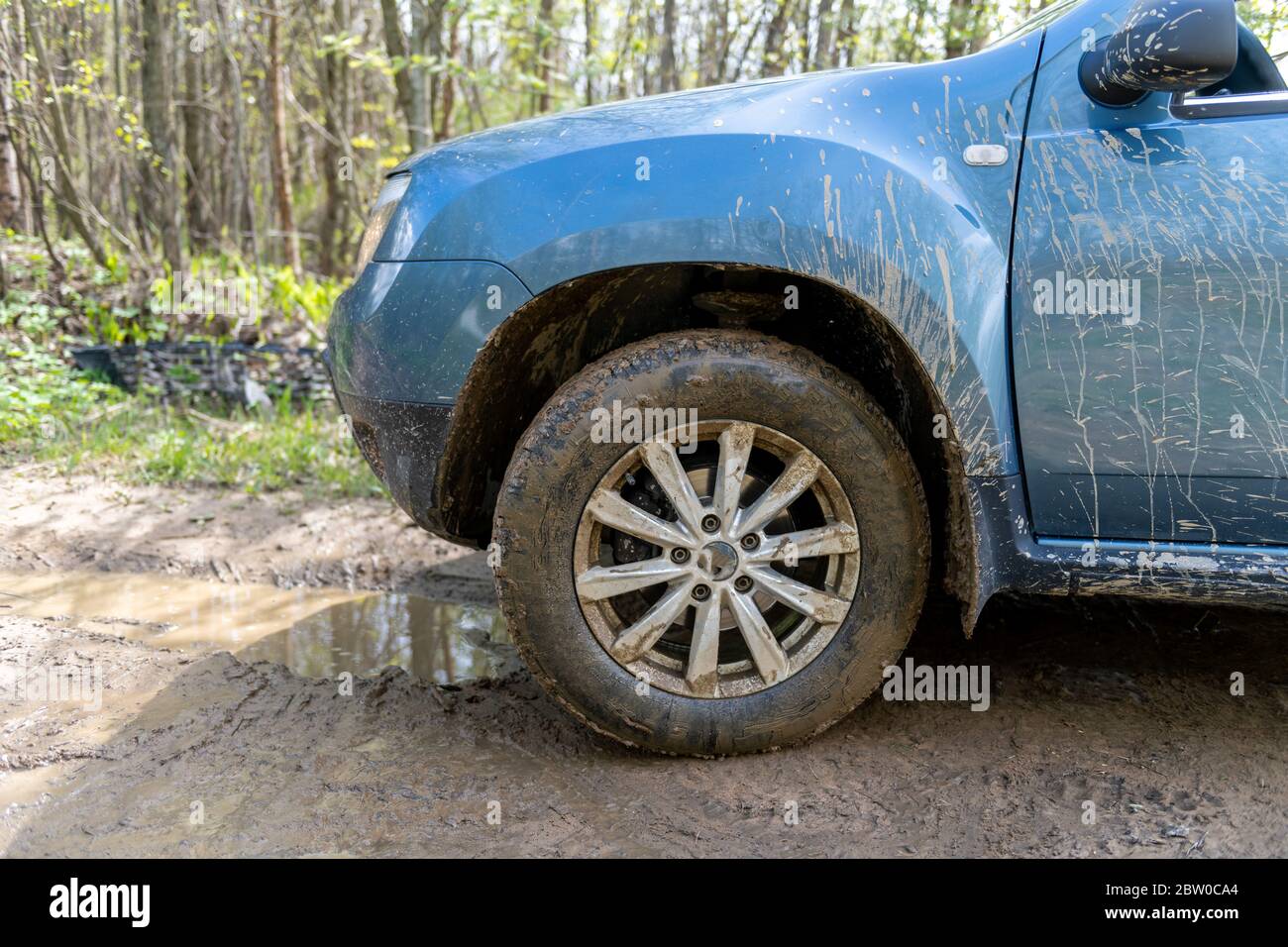 Dirty car wheel closeup in a countryside road. Off road concept. 4x4 ...