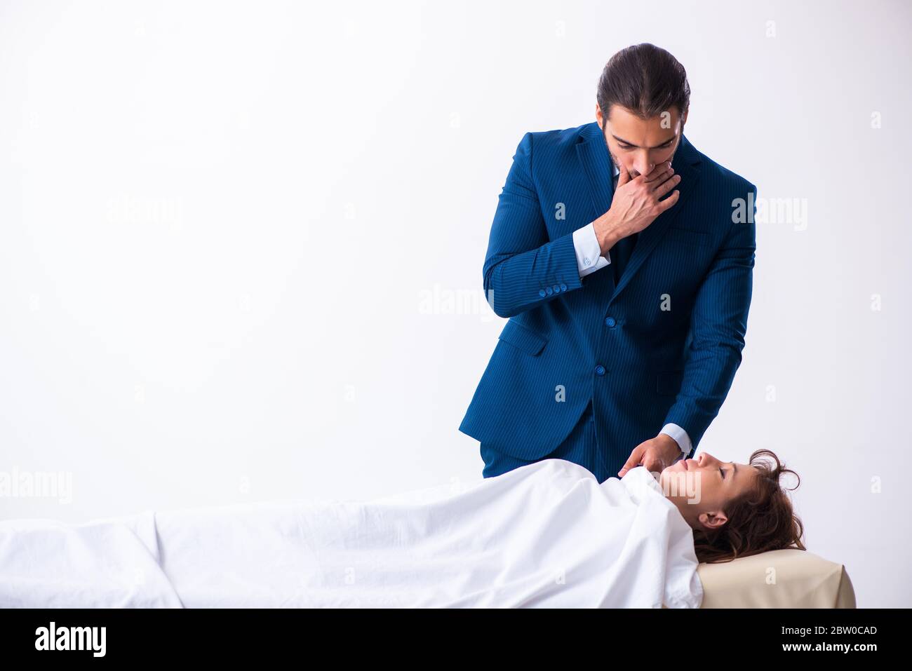 Police coroner examining dead body in morgue Stock Photo - Alamy