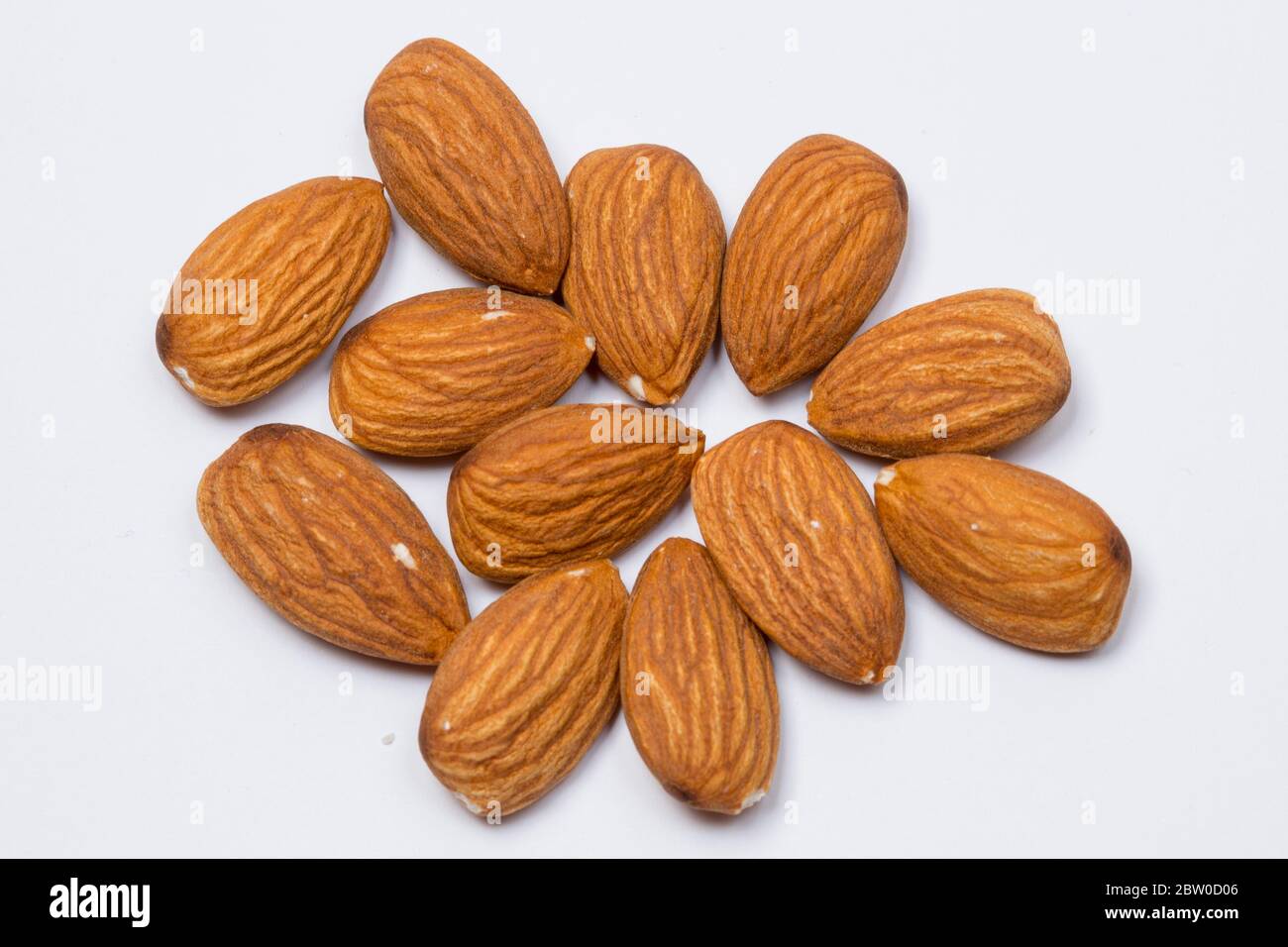 Close-up view of almonds on white background Stock Photo - Alamy