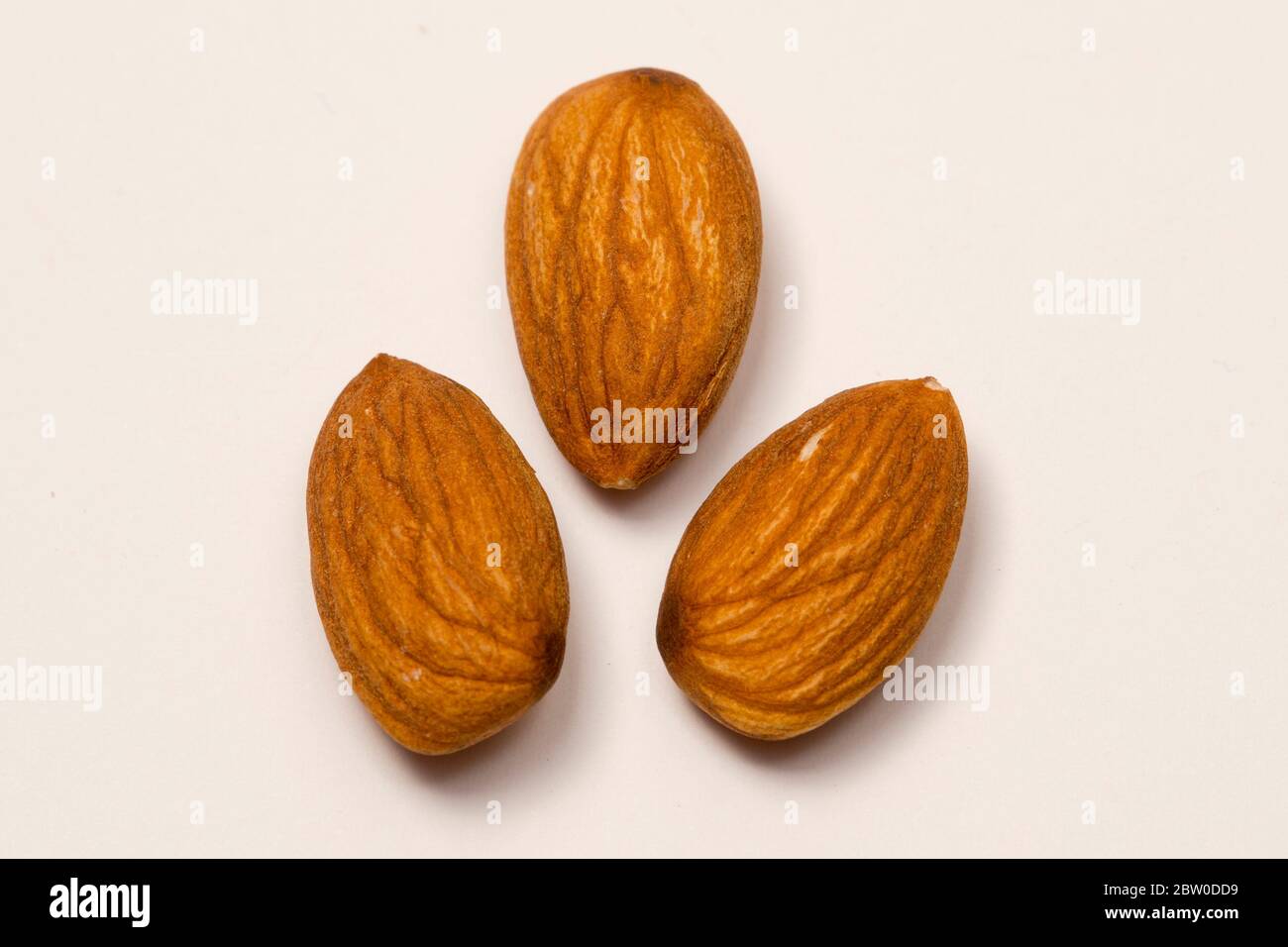 Close-up view of almonds on white background Stock Photo - Alamy