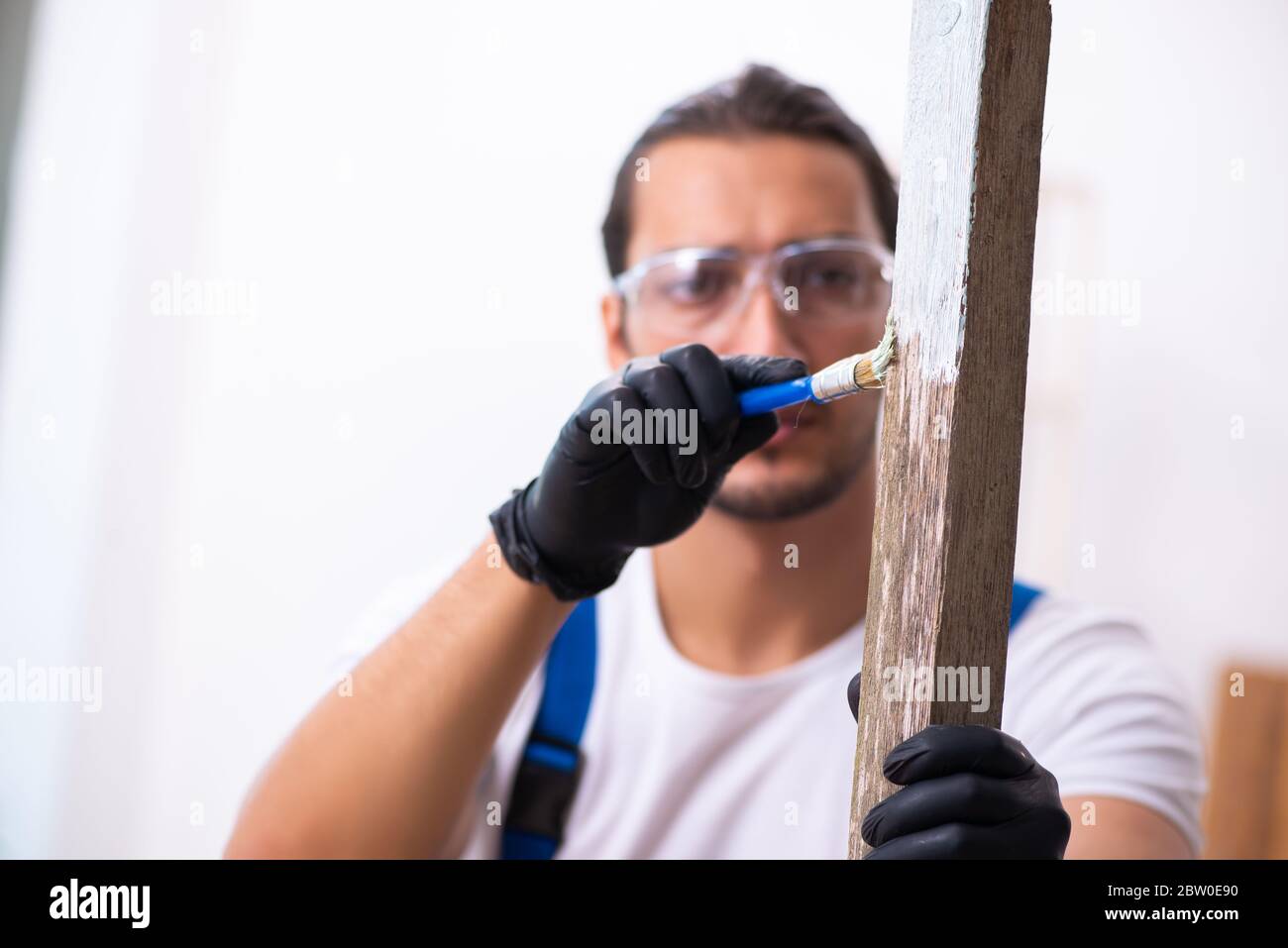 Young male contractor working in the workshop Stock Photo - Alamy