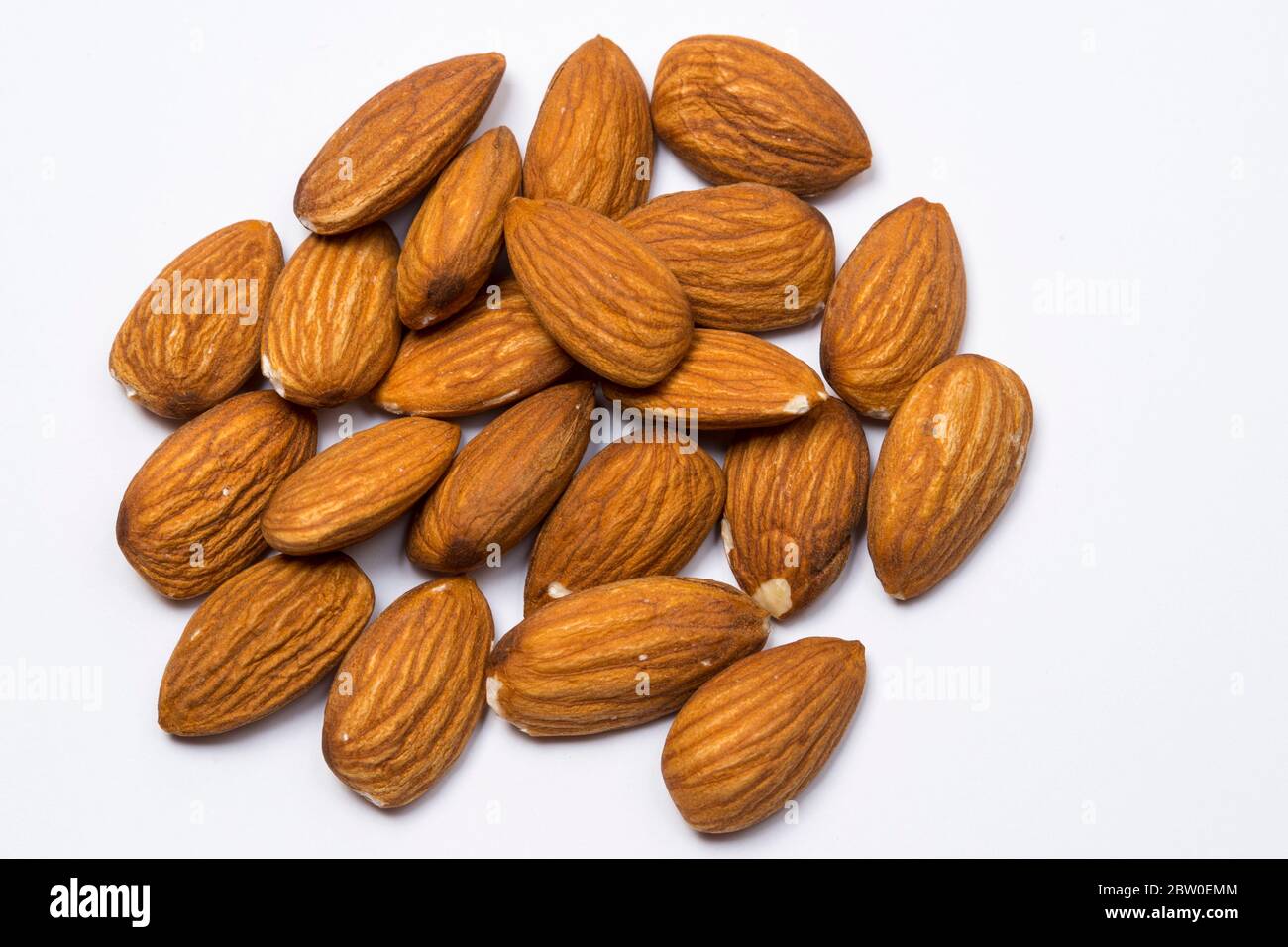 Close-up view of almonds on white background Stock Photo - Alamy