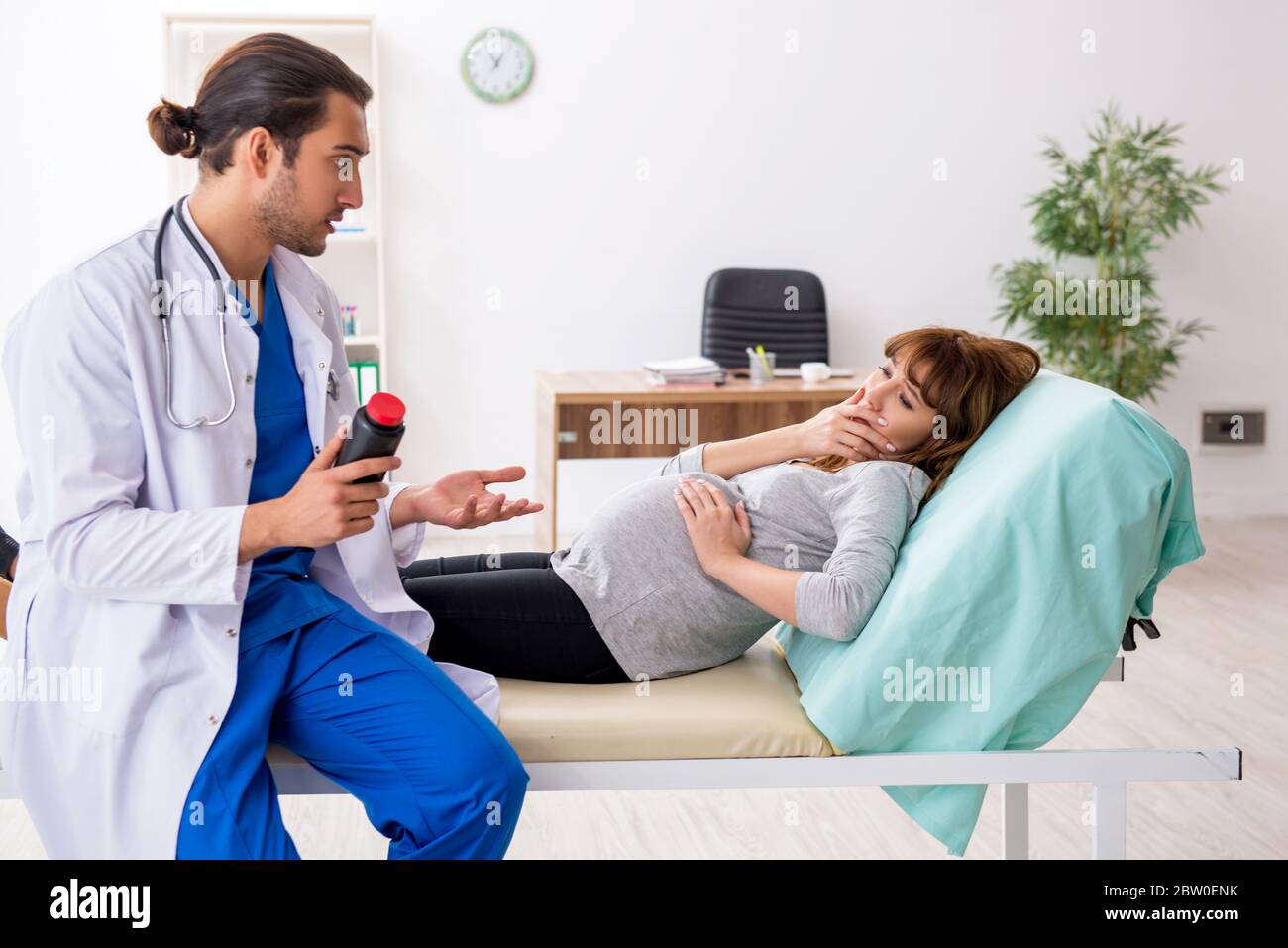 Young woman visting young male doctor Stock Photo - Alamy