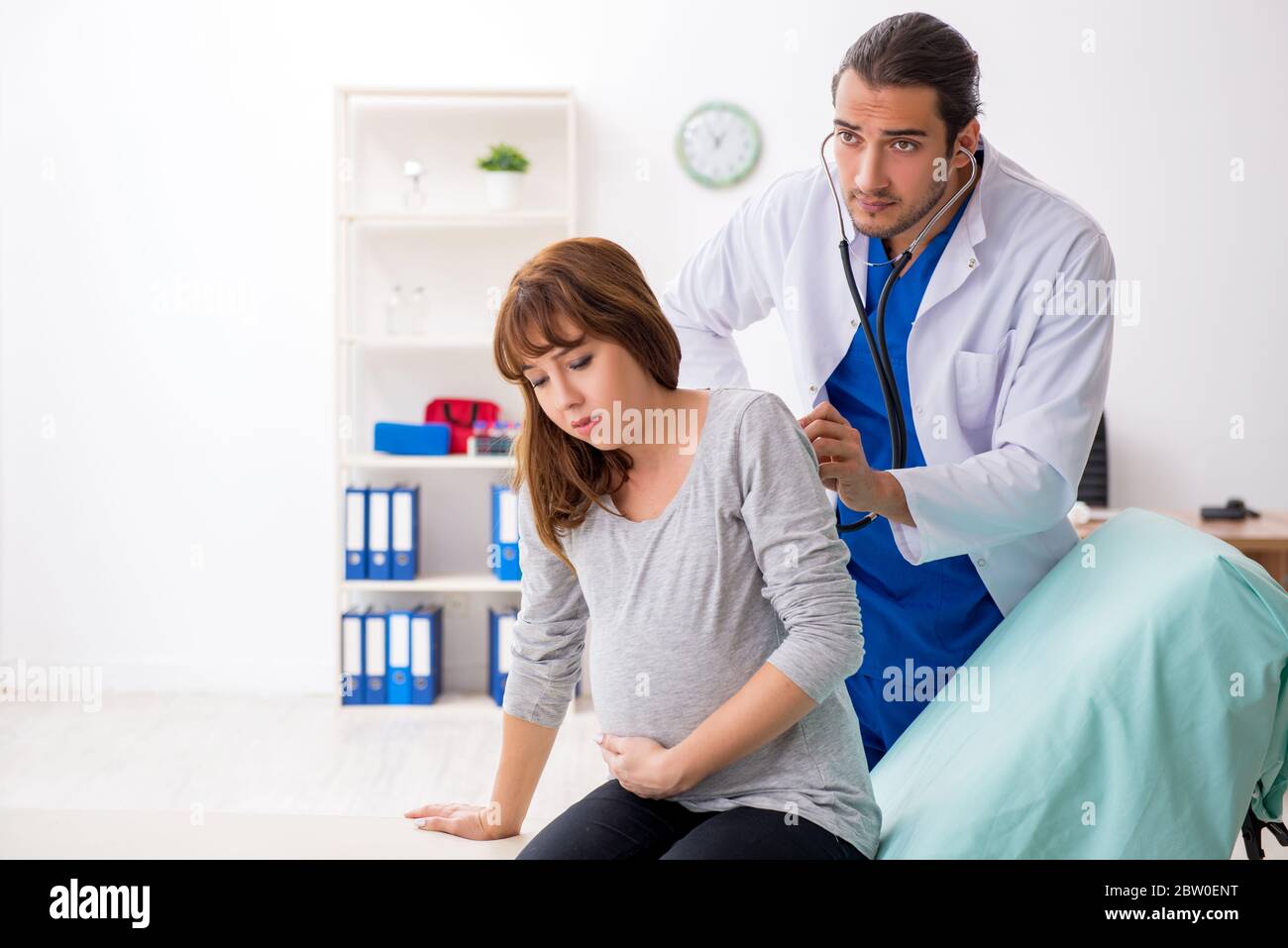 Young woman visting young male doctor Stock Photo - Alamy