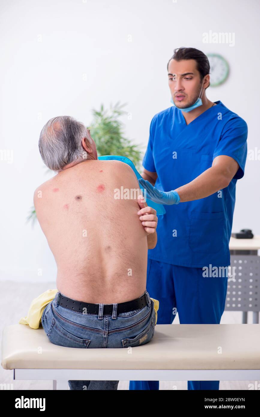Old man visiting male doctor dermatologist Stock Photo - Alamy