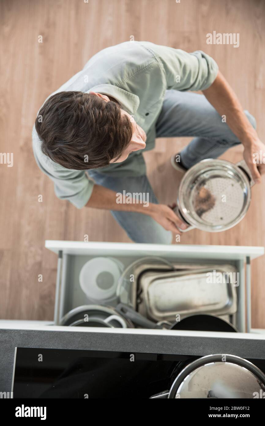 top view. a man taking out utensils from kitchen table Stock Photo - Alamy