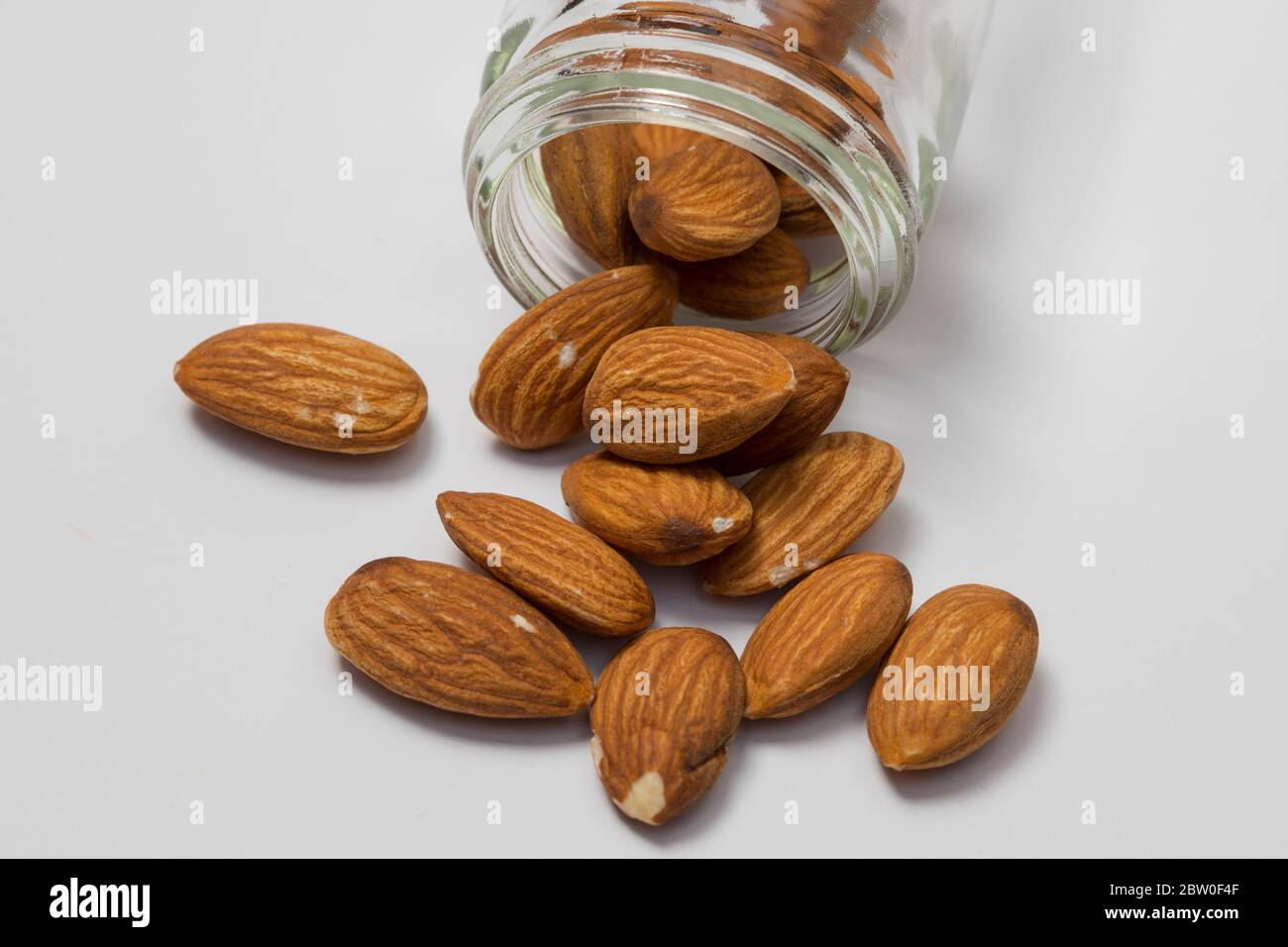 Close-up view of almonds on white background Stock Photo - Alamy