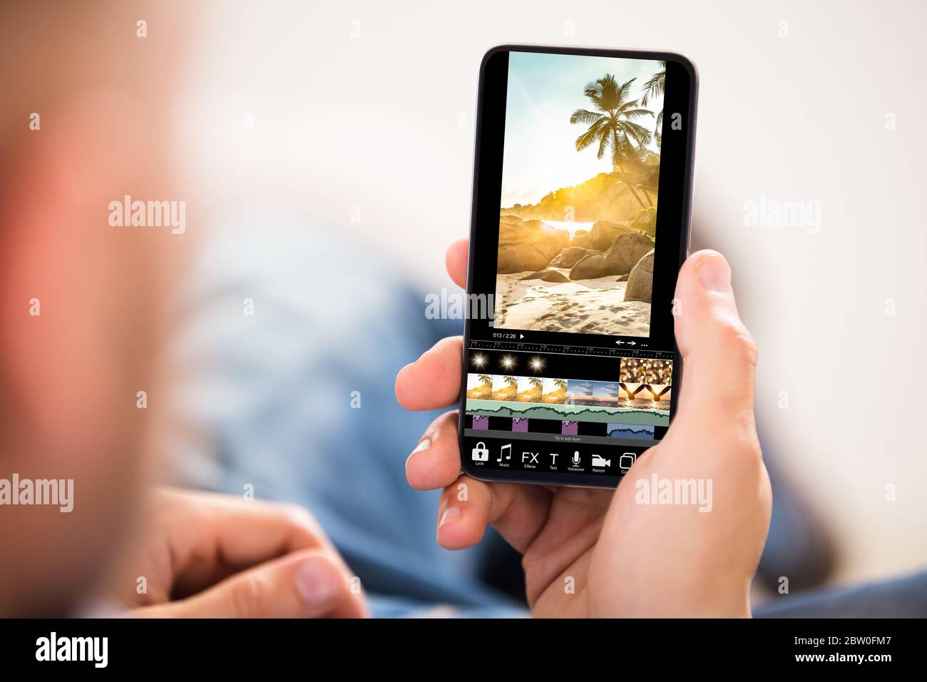 Editing Videos On Mobile Phone Using Video Editor App Stock Photo - Alamy