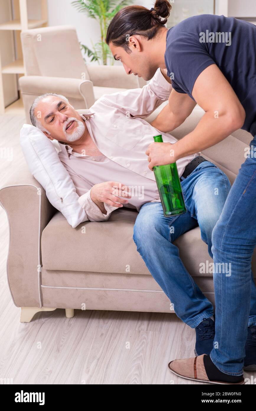 Drinking problems in the family between son and father Stock Photo - Alamy