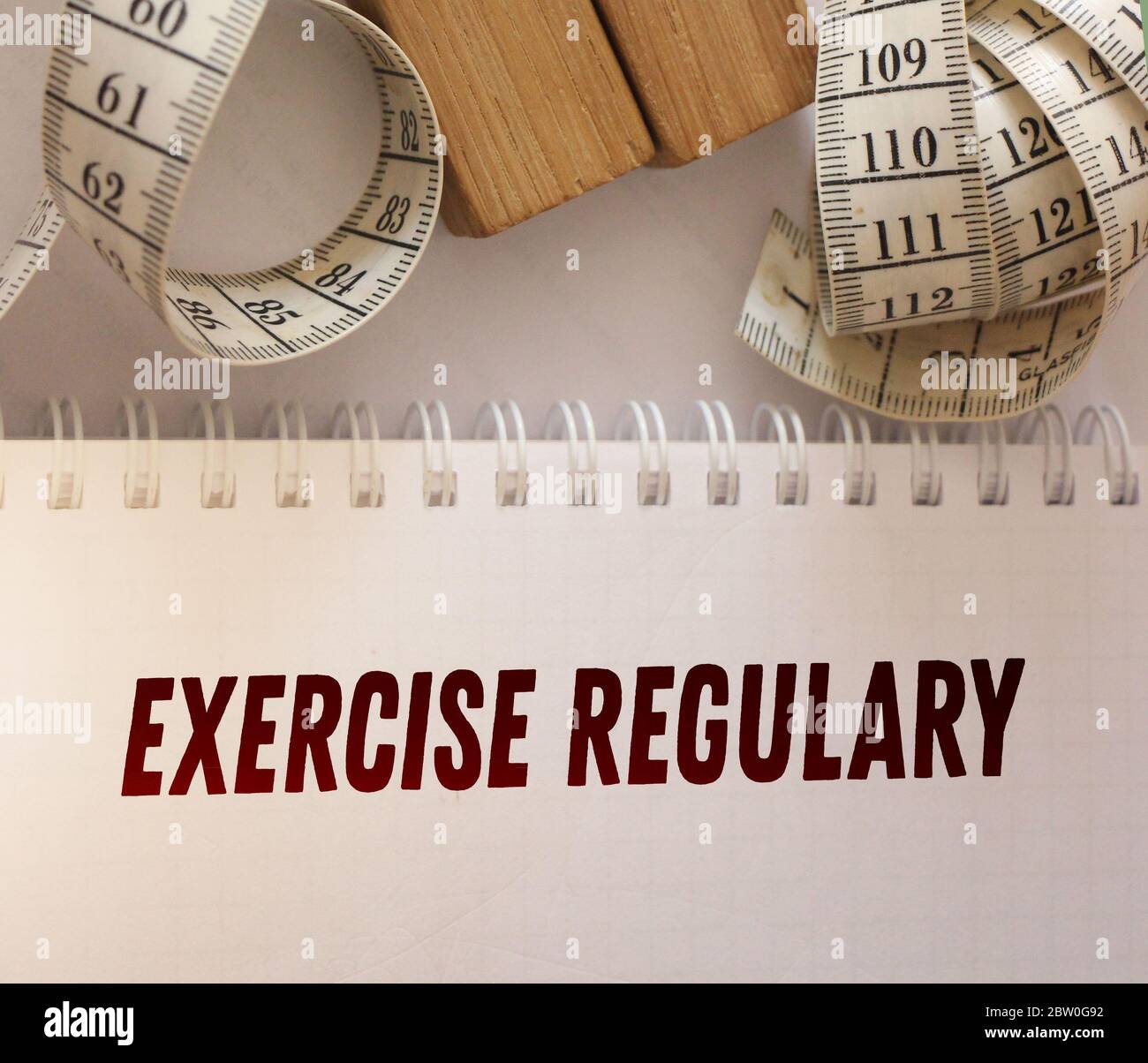 Measurement tape and Exercise regulary words on the page of copybook ...