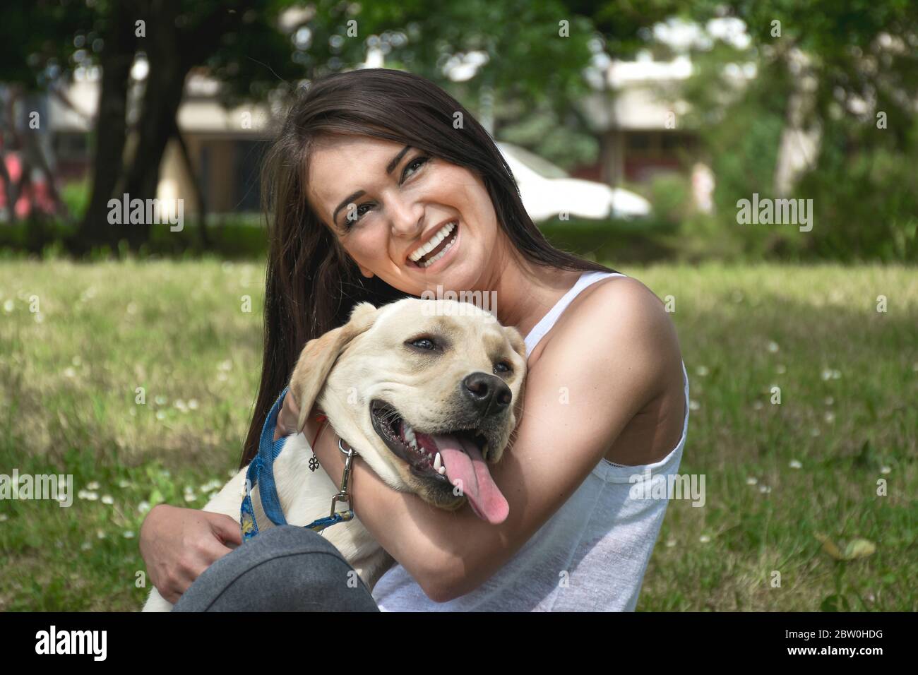 The young girl, hugs her deog tightly Stock Photo - Alamy