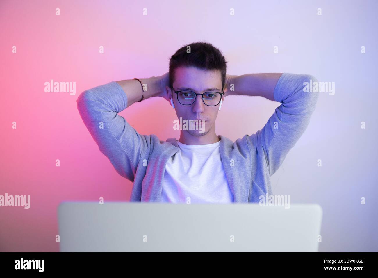 Gamer plays on a laptop. The programmer writes the code. Man on a ...