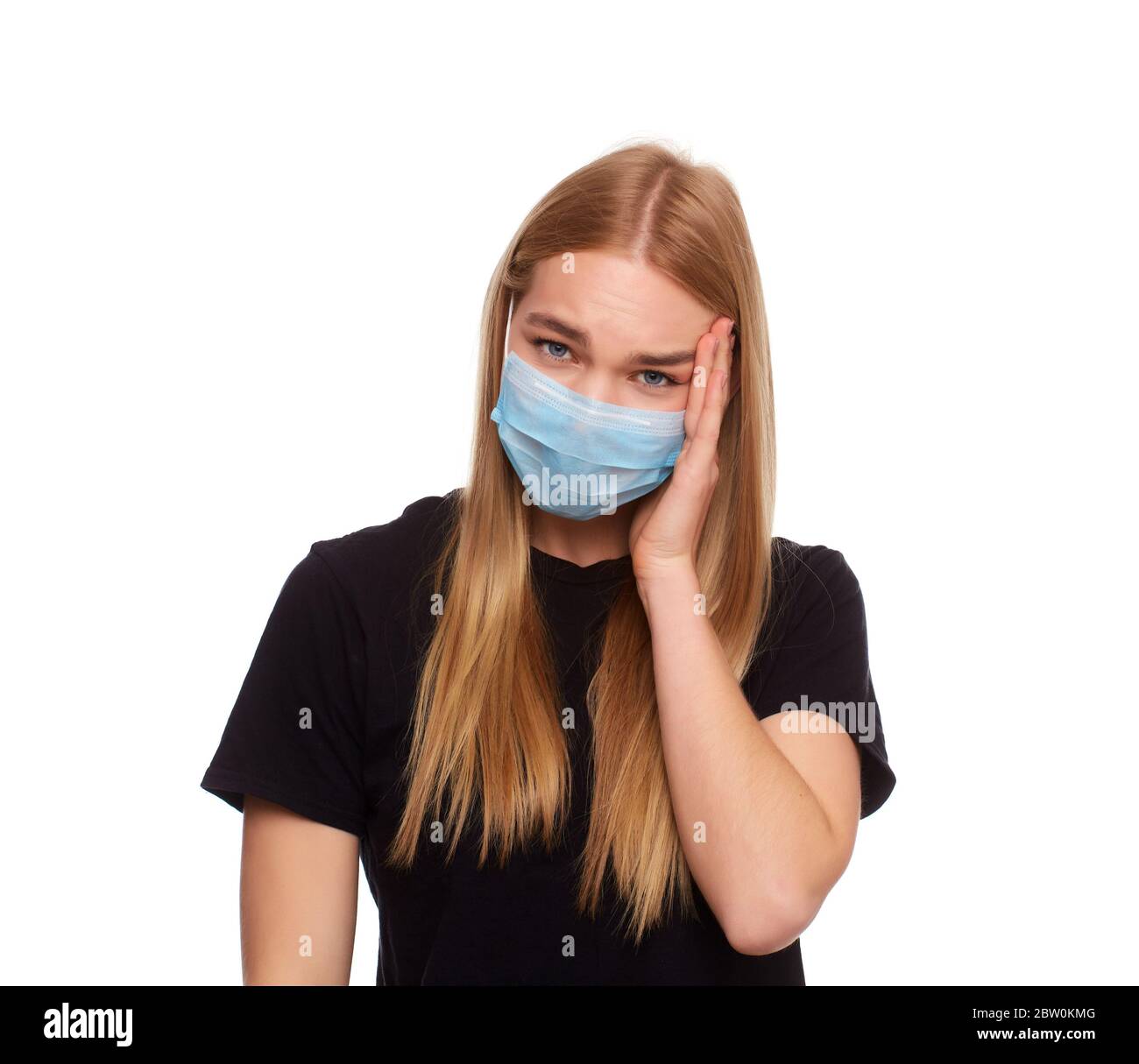 Studio portrait of young blonde illness girl with closed eyes, wearing ...