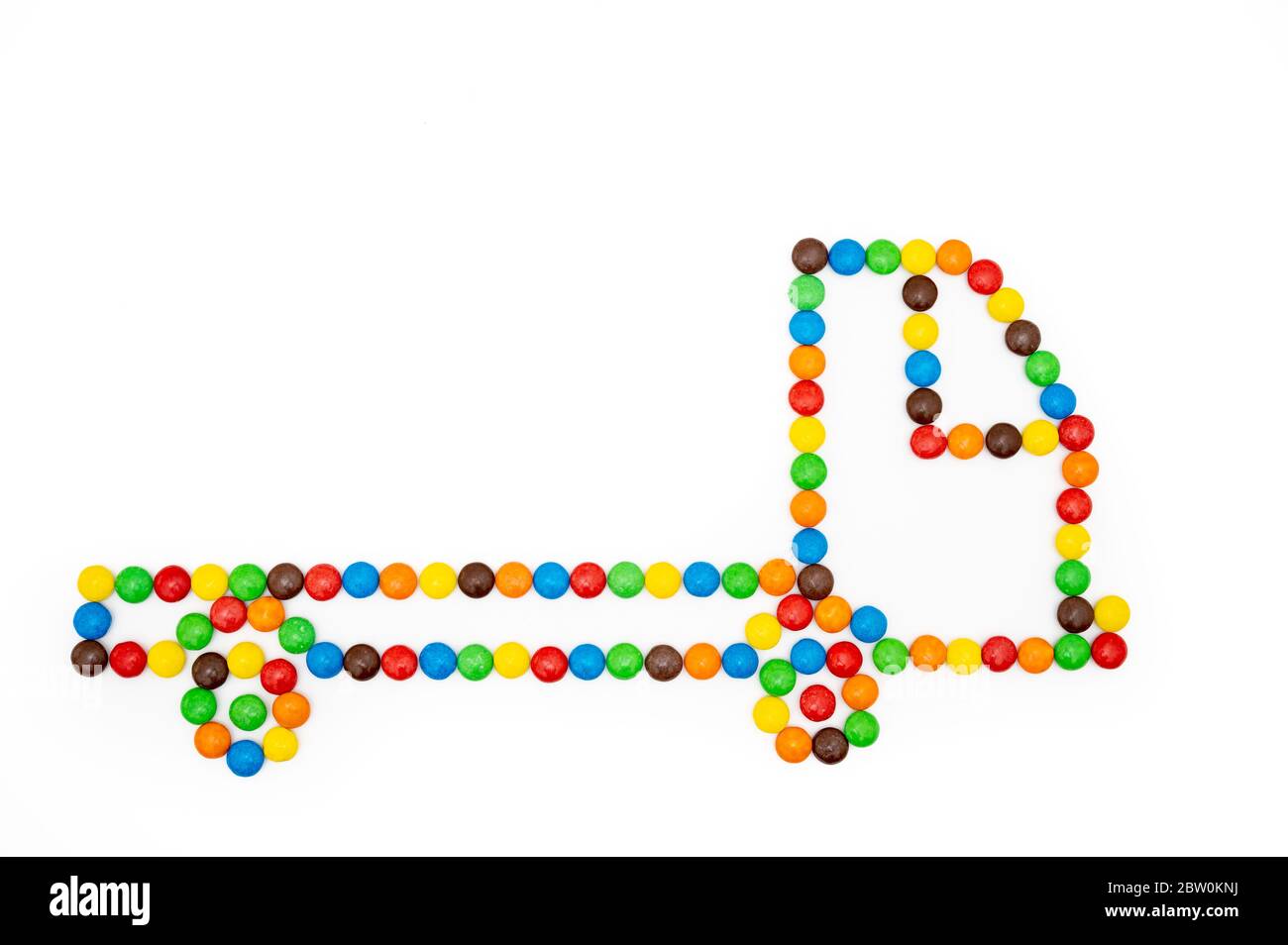 Truck shape made of colorful candies on black background Stock Photo ...