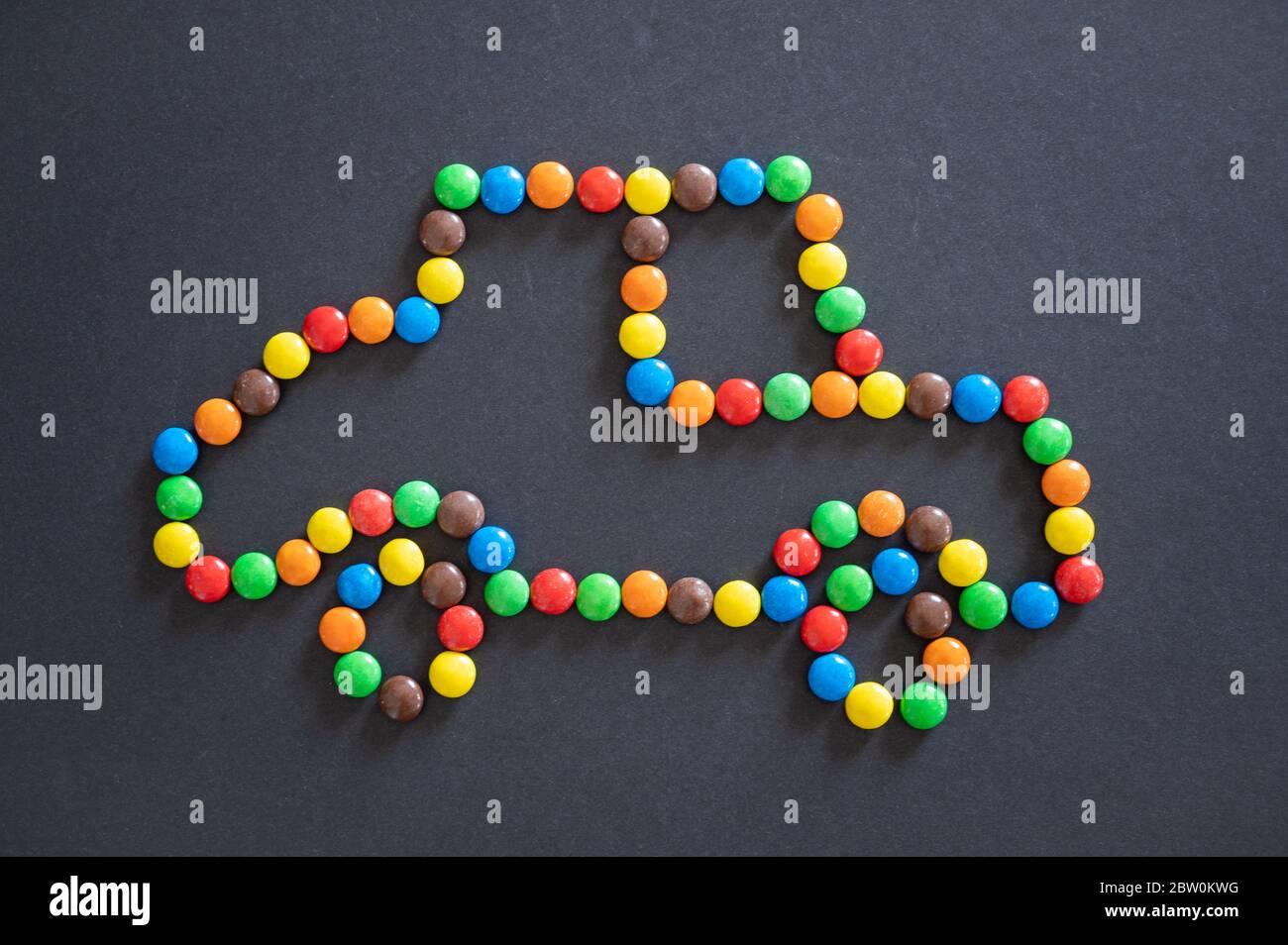 Car shape made of colorful candies on black background Stock Photo - Alamy