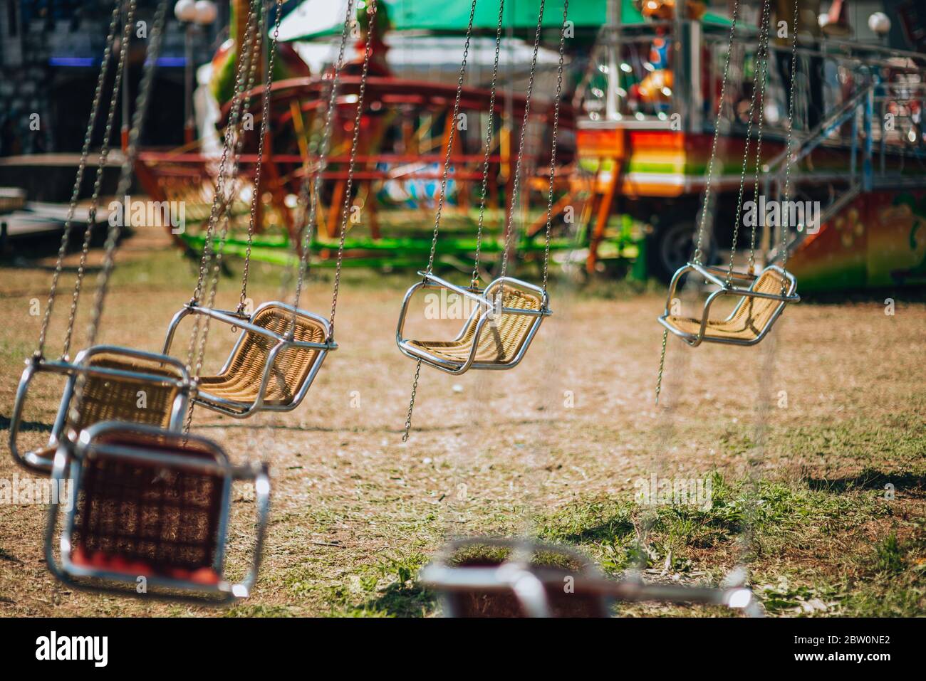 Colorful seats of a roundabout chain ride at the local theme park Stock ...