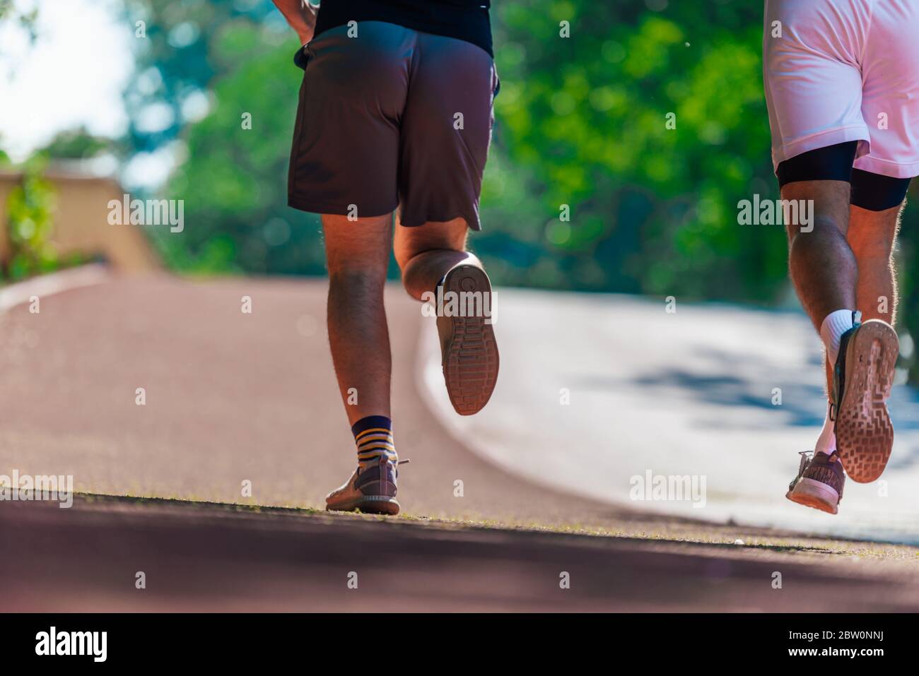 Close up feet with running shoes and strong athletic legs of sport man ...