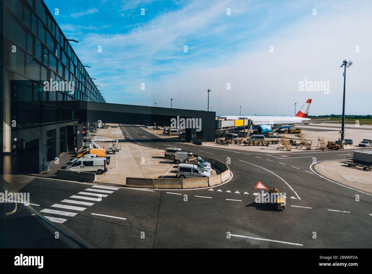 Passenger boarding bridge attached to an airplane at the aerodrome ...