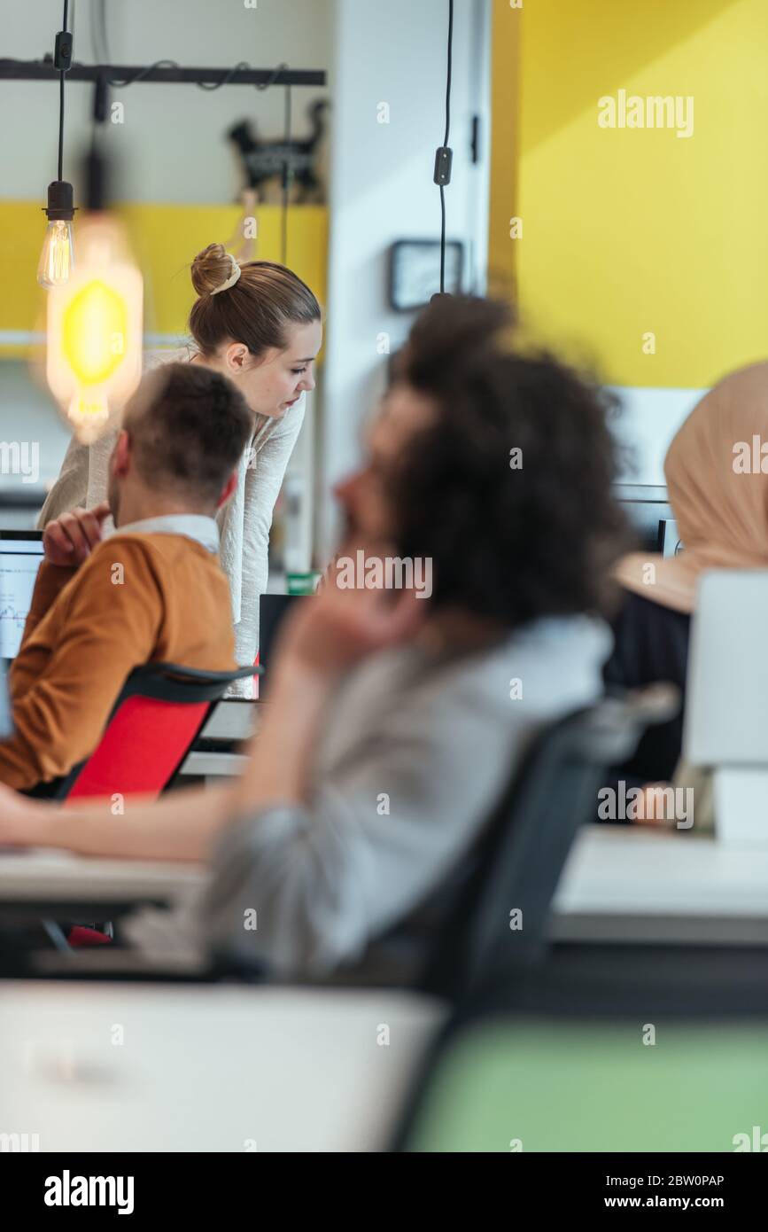 Bearded employee guy with afro haircut talking on his phone while being ...